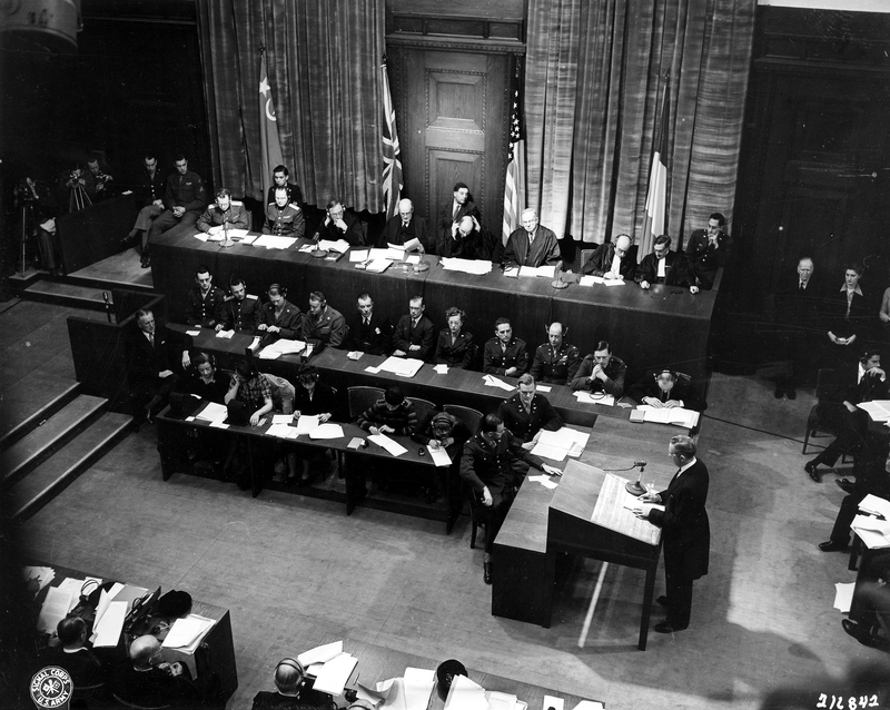 Sidney S. Alderman reads the charging indictment at the Nuremberg war ...