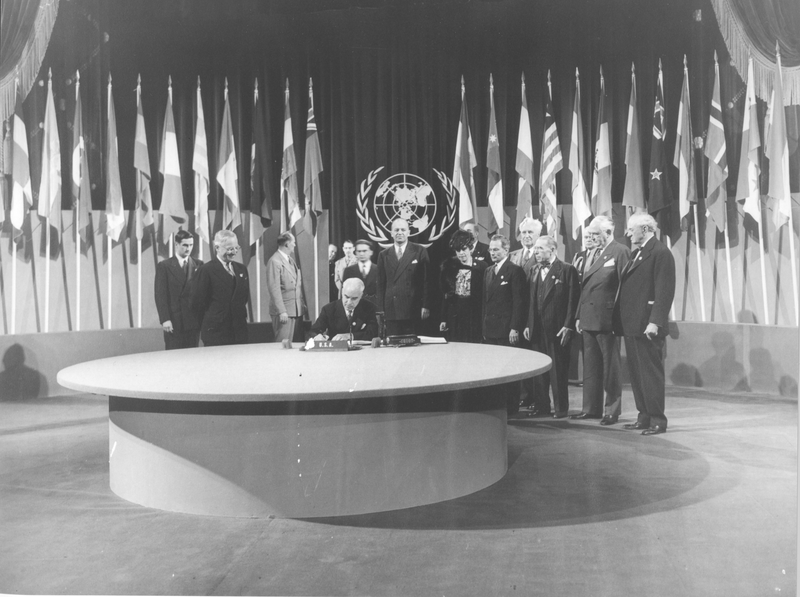 Signing of the United Nations charter by Stettinius as Truman watches ...