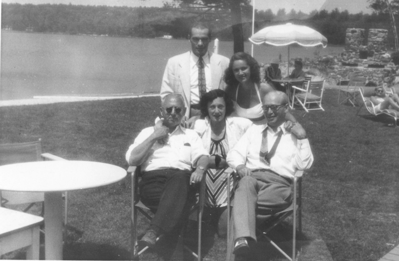 Seated left, David K. Niles with four unidentified people at the shore ...