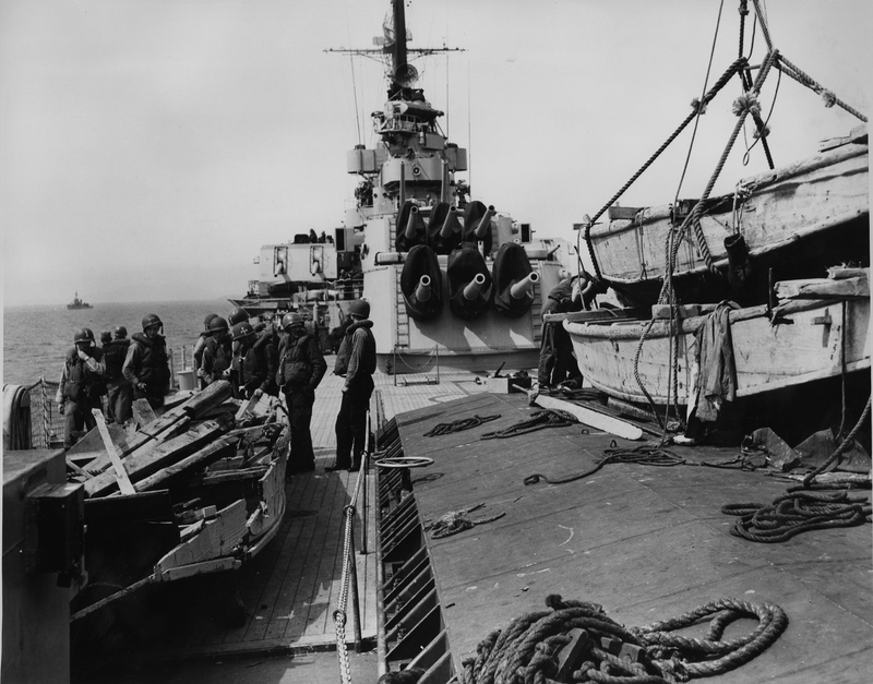 USS Manchester Crew Members Examine a North Korean Sampan | Harry S. Truman