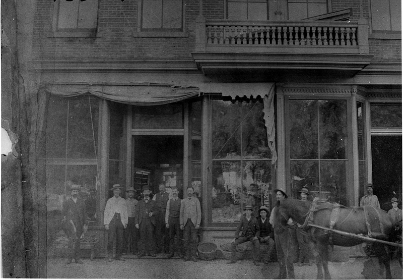 Group of men outside a store building | Harry S. Truman