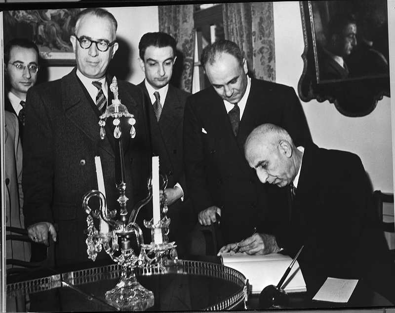 Prime Minister Mohammed Mossadegh of Iran signing the guest book at ...
