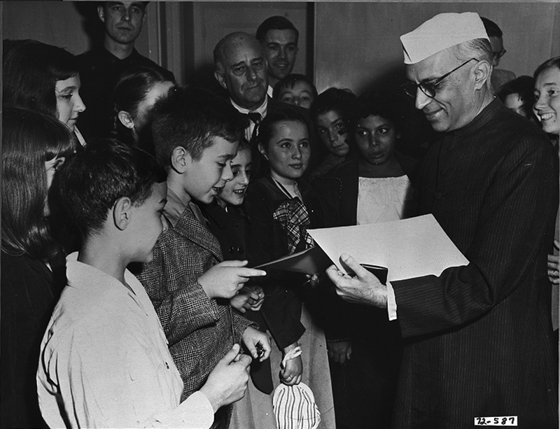 Prime Minister Nehru gives autographs to children | Harry S. Truman