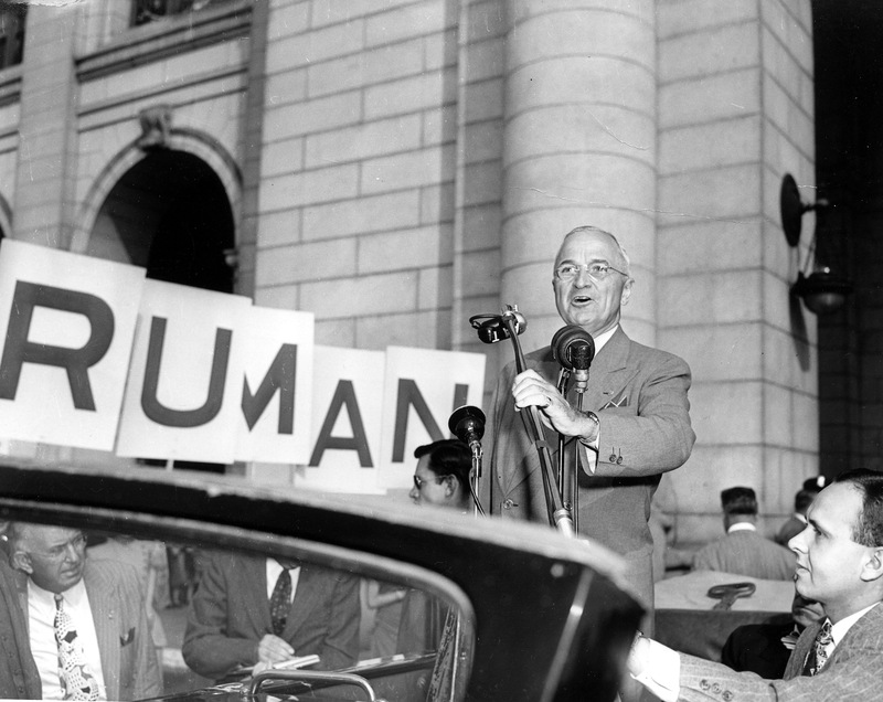 President Truman speaks to crowd from open car in Washington, D. C ...
