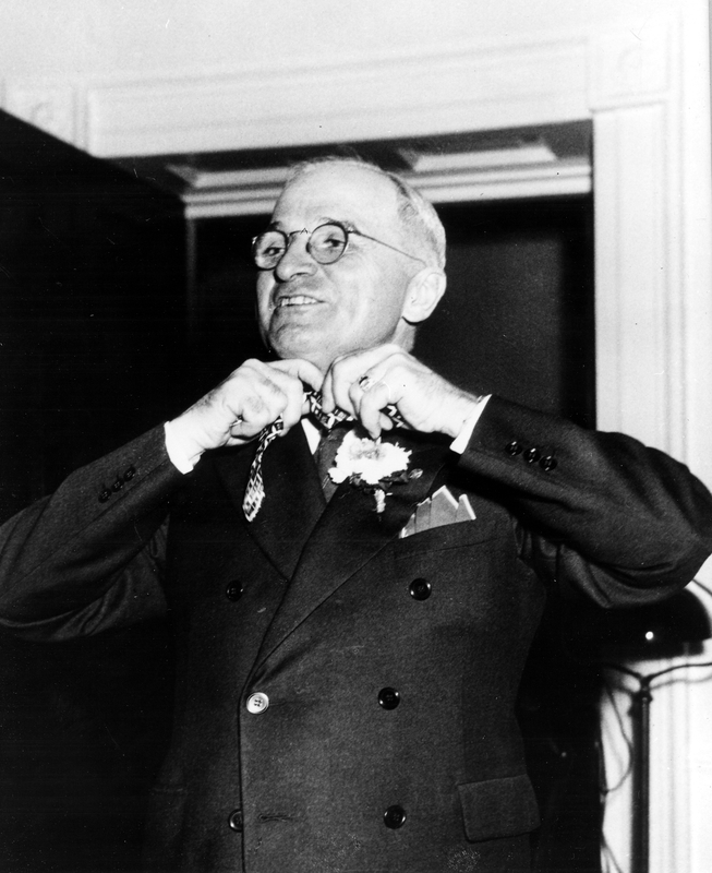 President Truman tries to tie his bowtie during the celebration of his ...