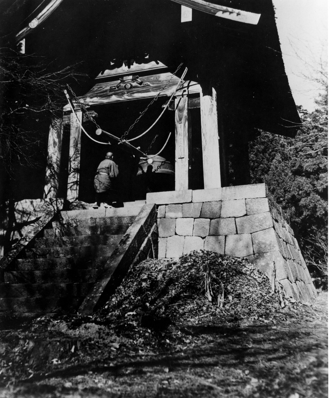 Japanese bell ringer is shown ringing one of the big bells at the ...