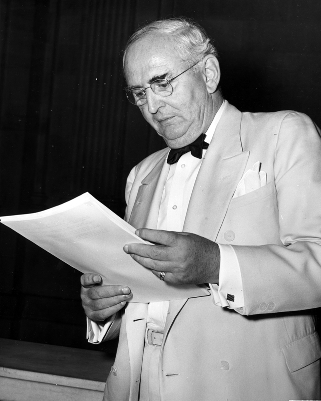 Senator Arthur H. Vandenberg standing, reading papers | Harry S. Truman