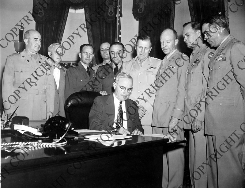 President Truman signing a document | Harry S. Truman