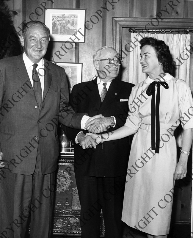 Edwin Pauley standing beside former President Truman shaking his left ...