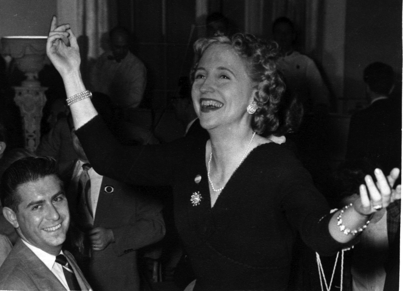 A laughing Margaret Truman in black dress and pearls | Harry S. Truman