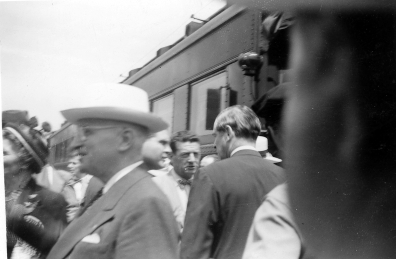 President Harry S. Truman at a train station surrounded by a group of ...