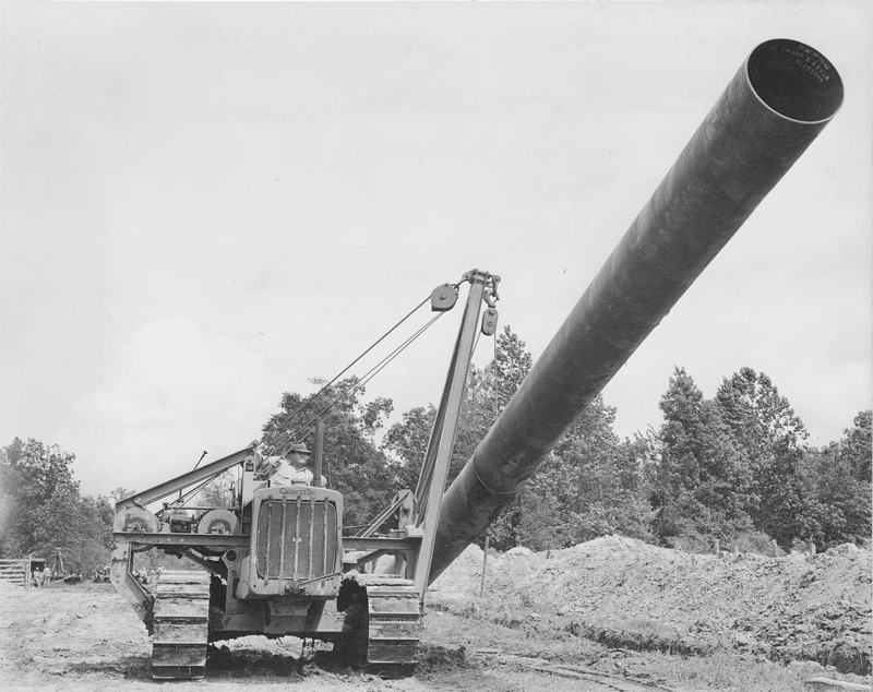 A Caterpillar moving a section of pipe | Harry S. Truman