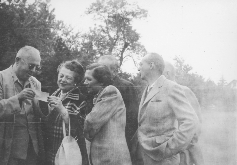David K. Niles, left, shows a photo to two women and two men | Harry S ...