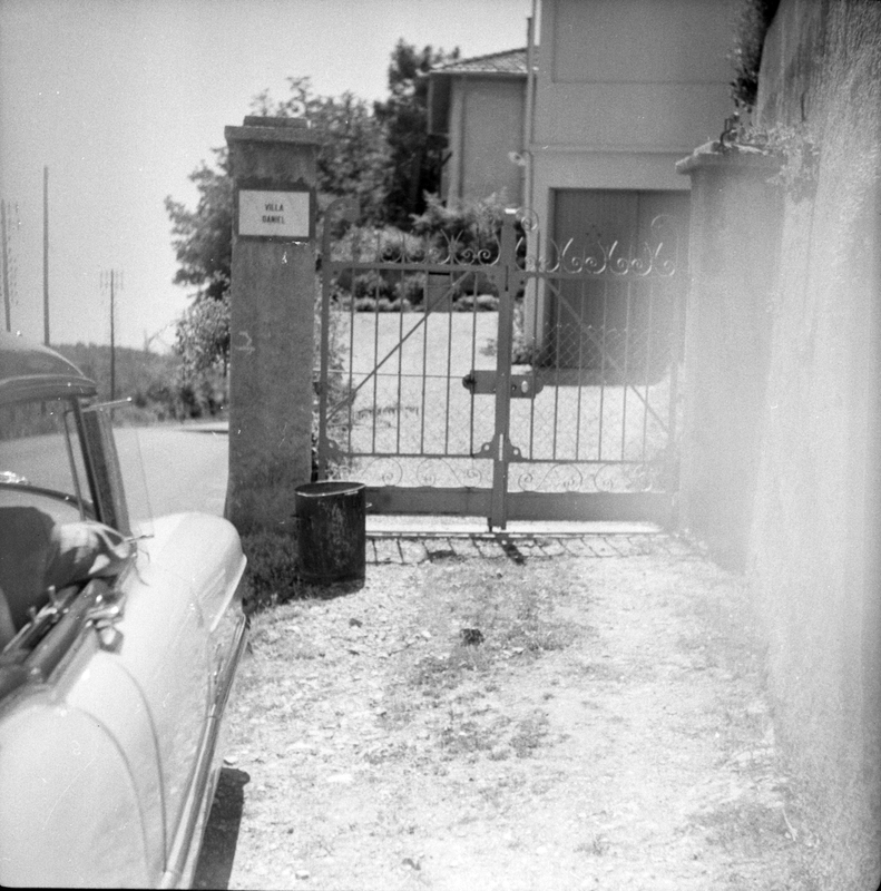 Photograph of a Gate, a Garage Door and the Side of a Car | Harry S. Truman