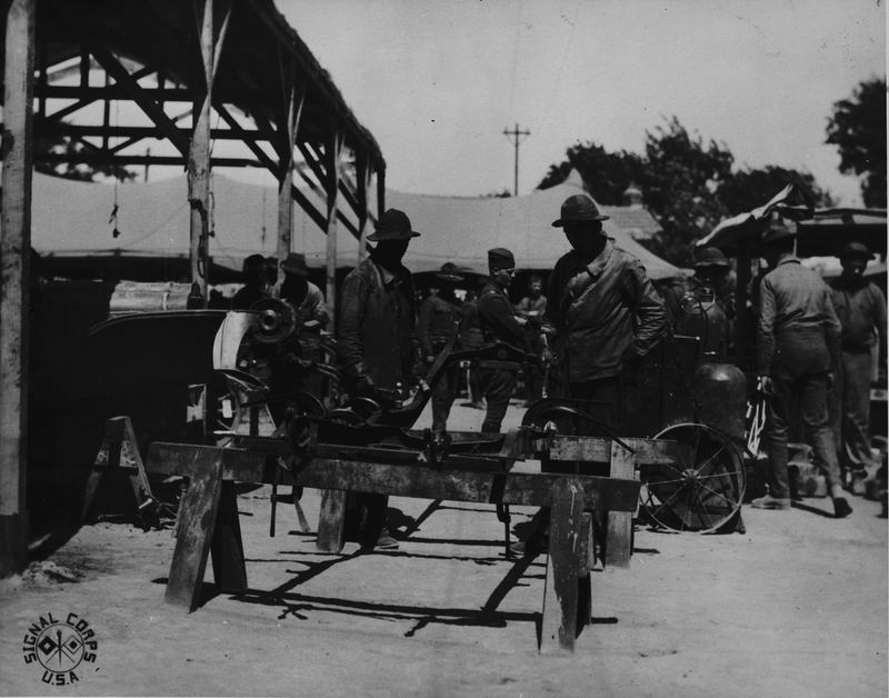Military motor pool where vehicles are being fixed during World War I ...