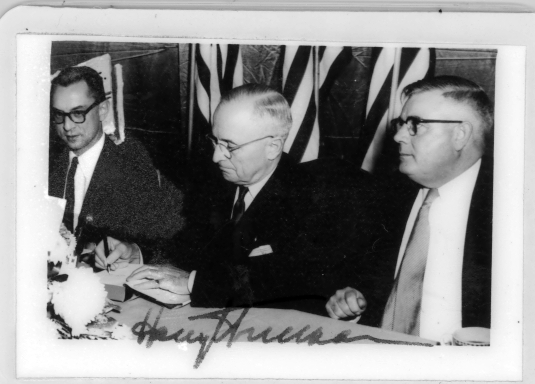 Former President Harry S. Truman Signing a Book | Harry S. Truman