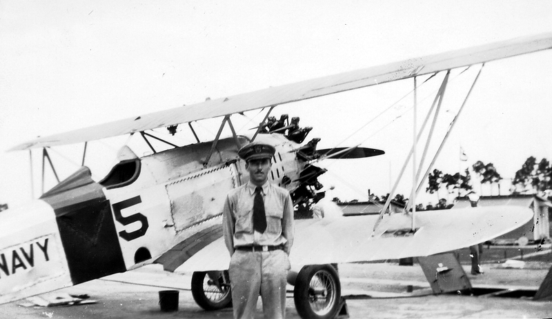 Pilot posing with a biplane | Harry S. Truman