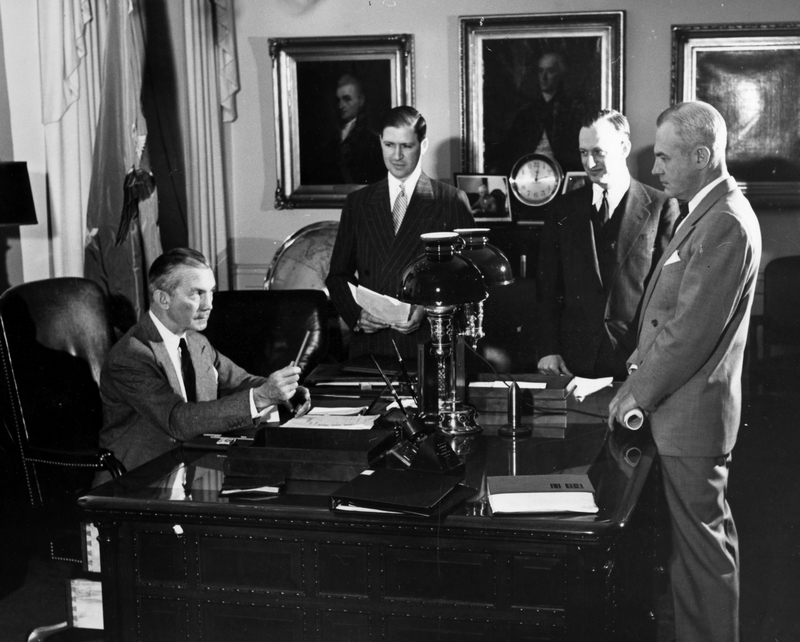 James Forrestal, Secretary of Defense, is shown seated at his desk ...