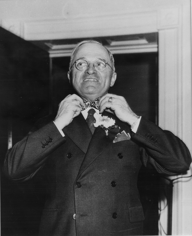 President Truman completes the tying of his bow tie during the ...