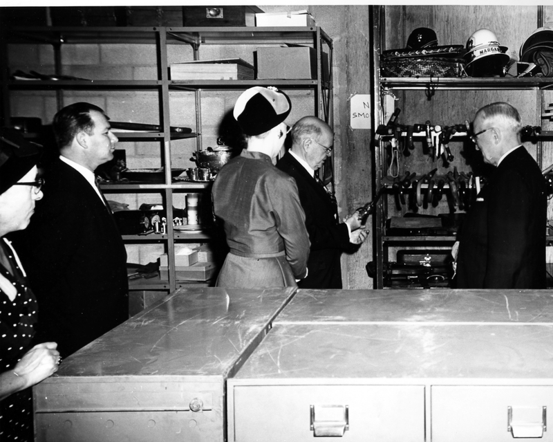 Harry S. Truman and a group of unidentified individuals in an artifact ...
