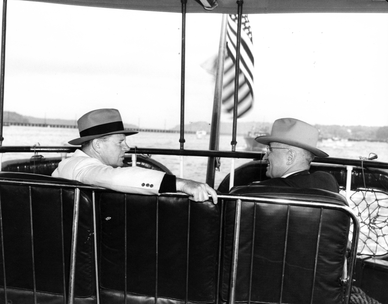 President Harry S. Truman on the deck of the boat Lenore sitting with ...