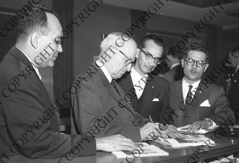 Side shot of former President Truman signing autographs | Harry S. Truman