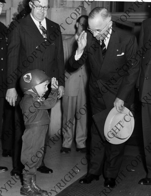 President Truman returns a salute offered by little Louis Jensen ...