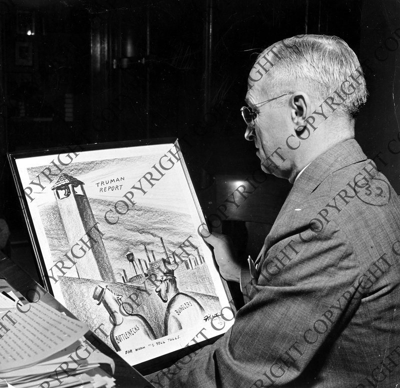 Senator Harry S. Truman Gazes at Cartoon Presented to him Showing the ...