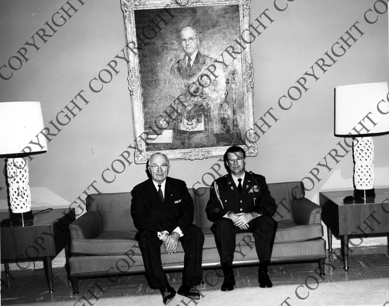 Former President Truman and Col. Robert E. Adams shown seated under ...