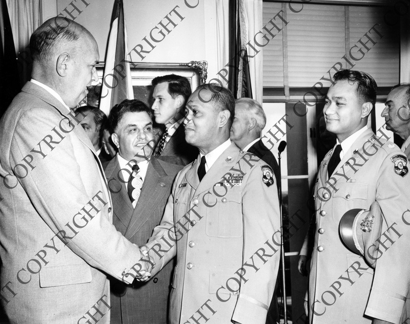 Secretary of Defense Louis Johnson greets unidentified military men ...