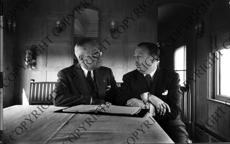 President Truman with unidentified man seated in his campaign train of ...